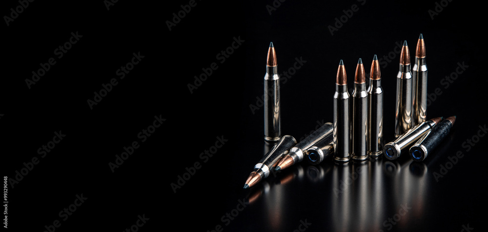 Bullet isolated on black background with reflexion. Rifle bullets close ...