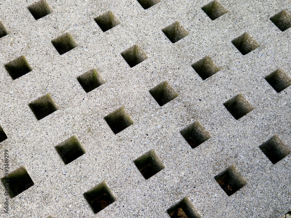 concrete slab with square-shaped holes in a regular grid. cover from ...
