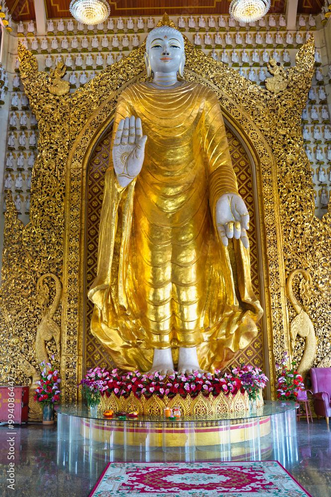 Statue of a Golden robed standing Buddha inside the Sasana Vamsa Sima ...