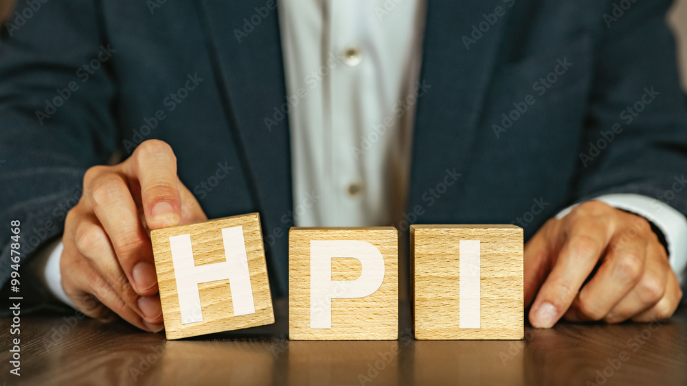 There is wood cube with the word HPI. It is an abbreviation for Human ...