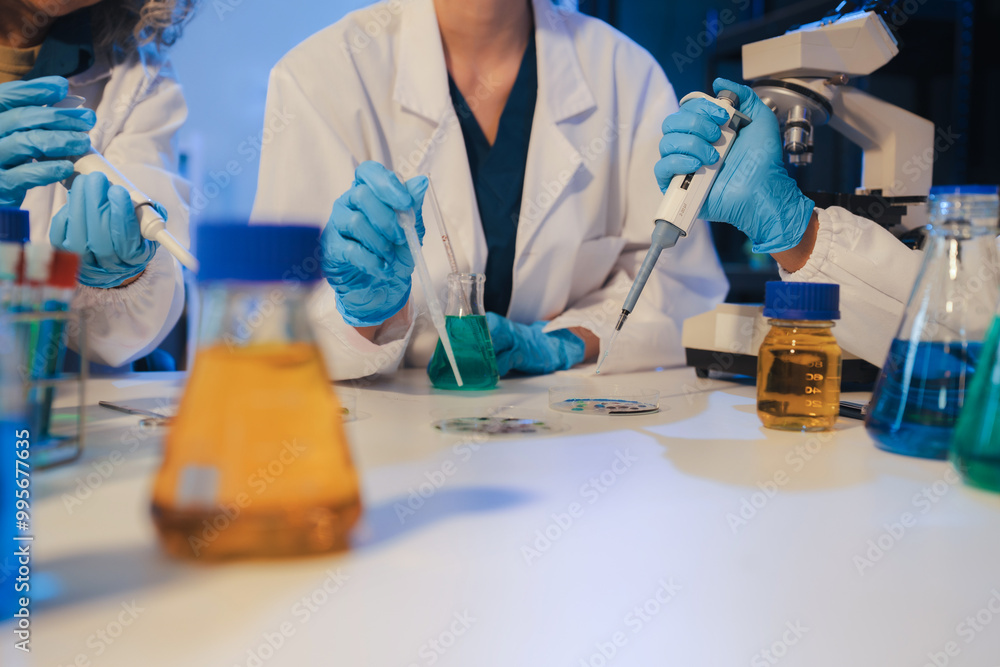Scientist mixing chemical liquids in the chemistry lab. Researcher ...