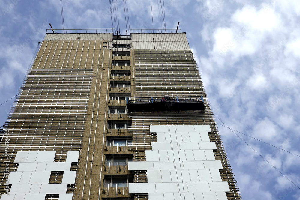 Bottom up view of being renovate high building with insulation on ...