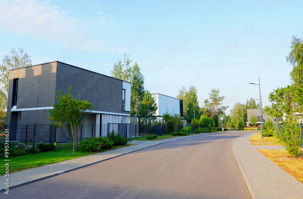 Rows of modern houses along road. Prefab house. Street in private ...