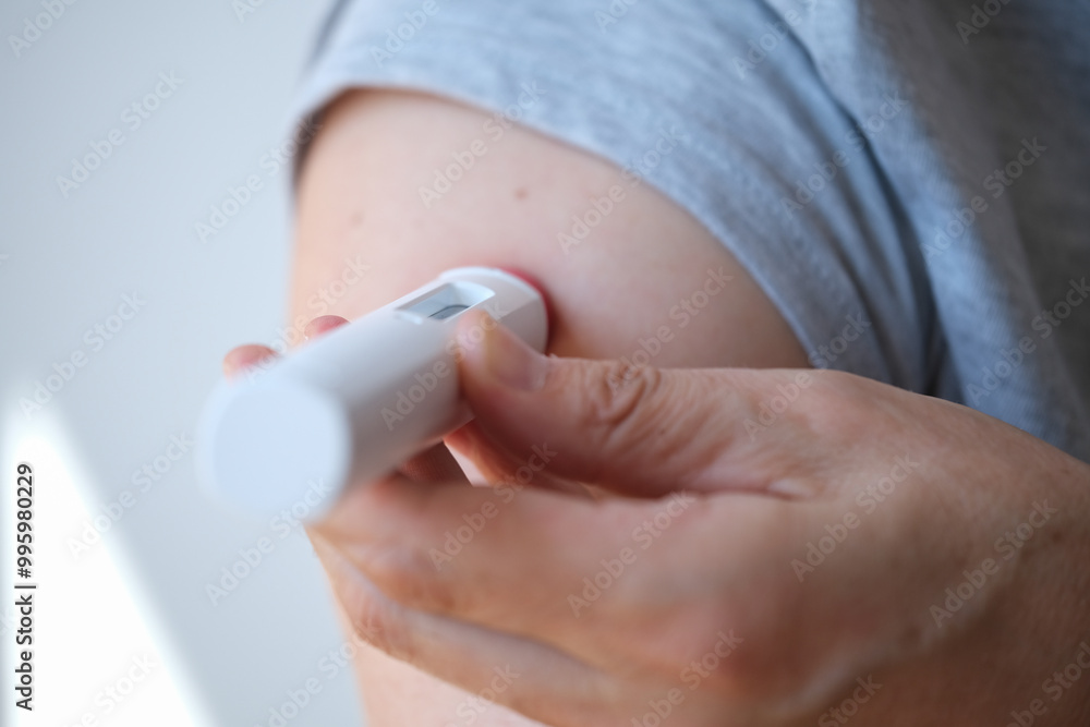 front close up of an anonymous person injecting himself a treatment ...