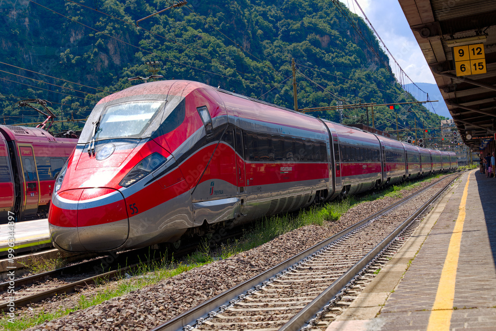 Red and silver colored high speed train named Frecciarossa arriving at ...