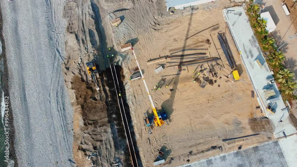 Batumi, Georgia - July 5, 2024:Construction workers install deep trench ...