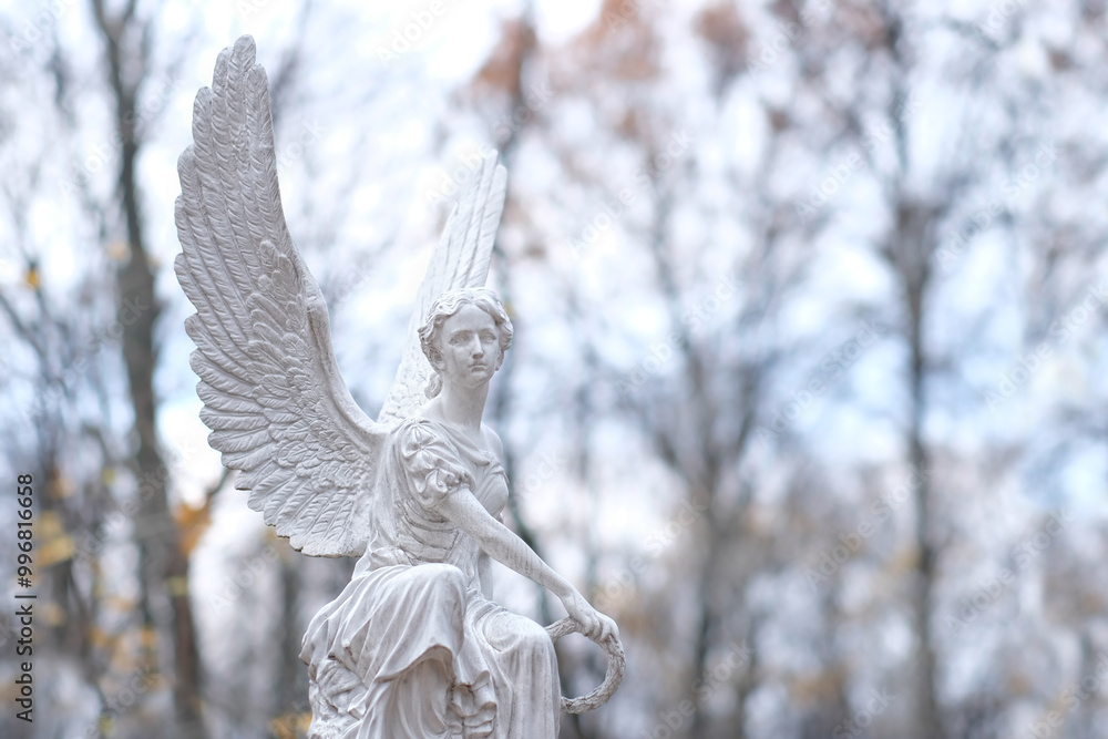 beautiful angel statue on cemetery, autumn nature background. Design ...