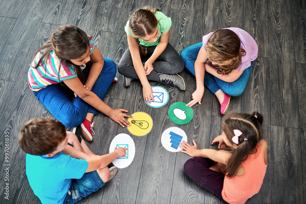 Kids, group and playing a game on floor with communication icons ...