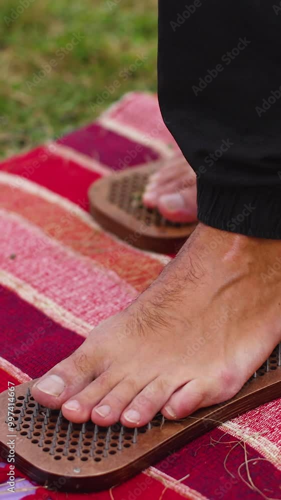 Standing on sadhu board, process of barefoot standing on nails therapy ...