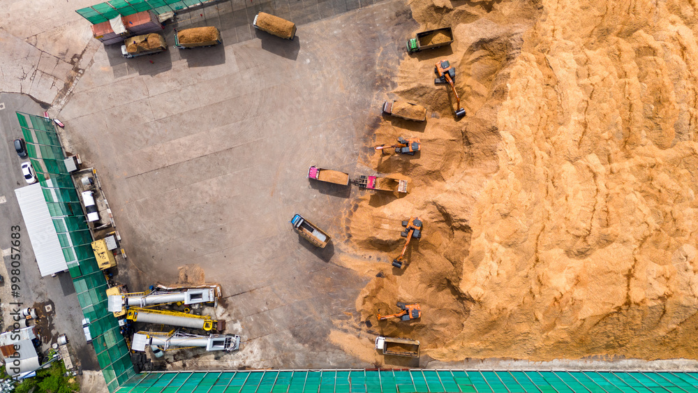 Aerial top view of wood chips with backhoe working load unload chip to ...