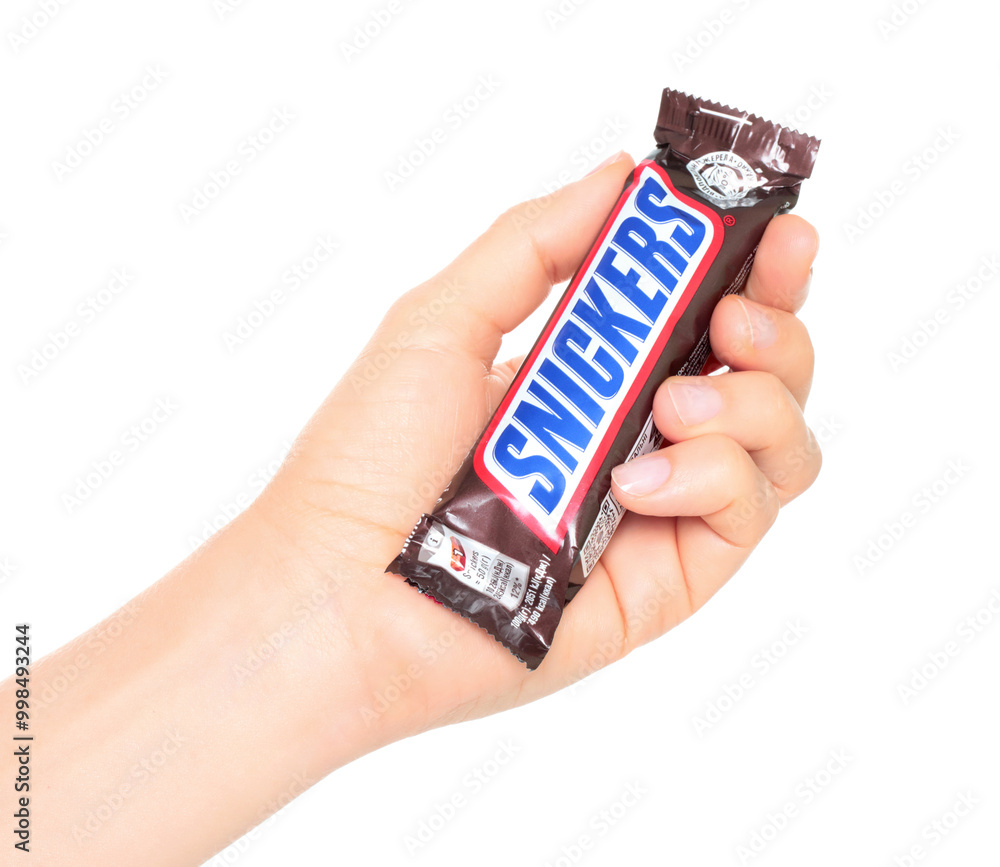 Hand holding Package of the Snickers - Chocolate Bar of Mars ...