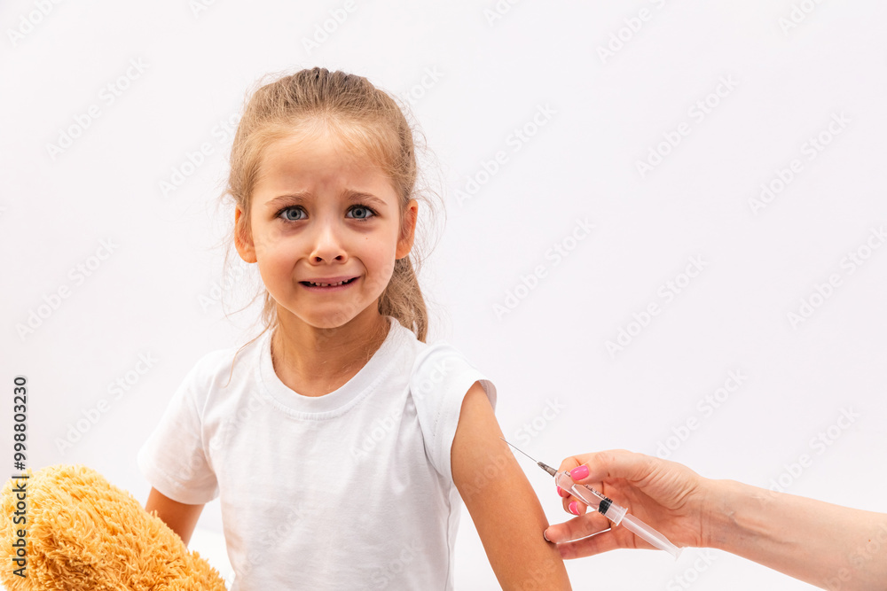 Vaccination of children, a little girl at a doctor's appointment, an ...