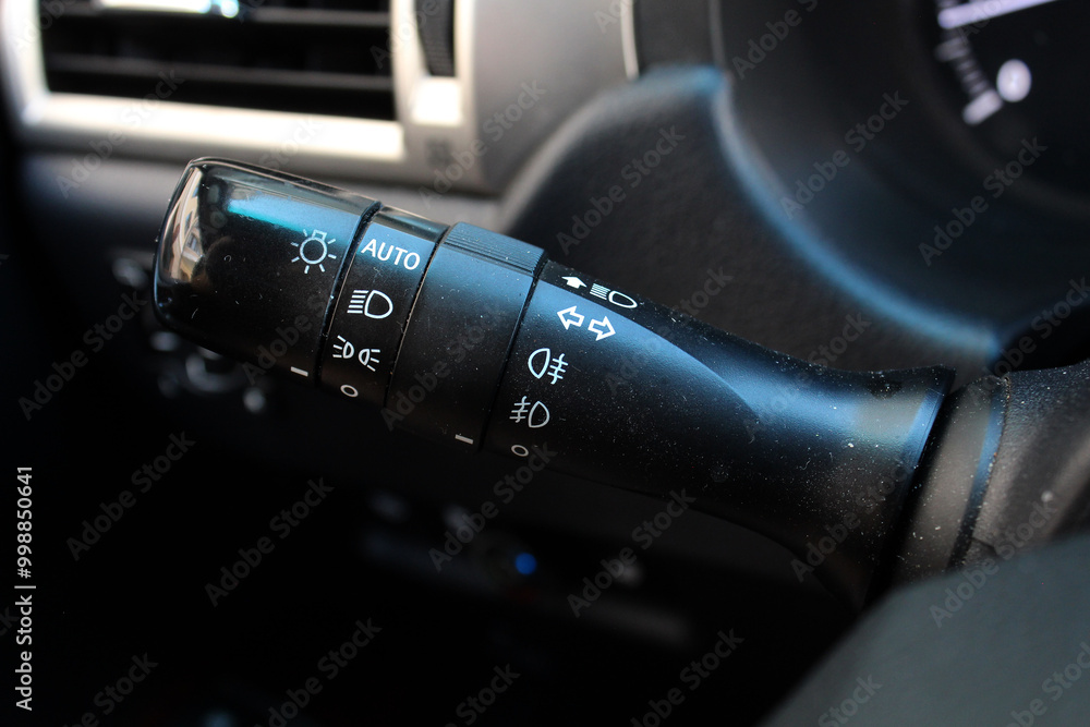 Low and high beam switch. Black light switch lever of an SUV vehicle ...