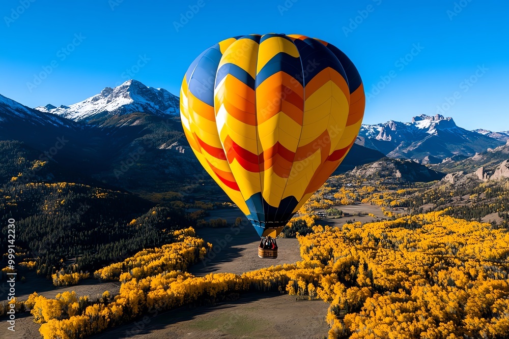 Hot air balloon over autumn mountains, soaring above golden trees ...
