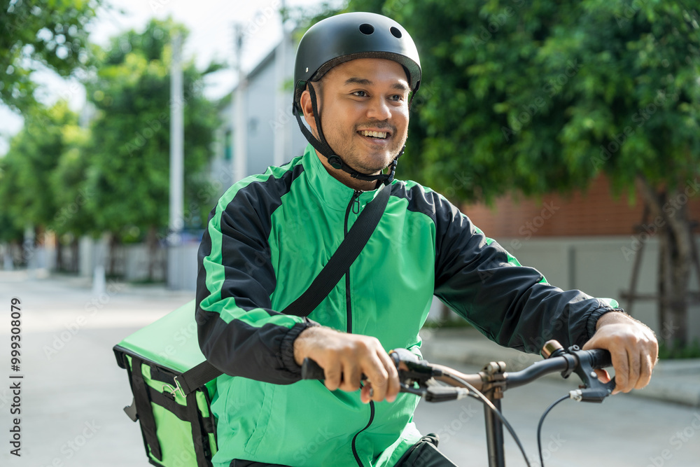 Portrait Rider food delivery man wearing green uniform and helmet ...