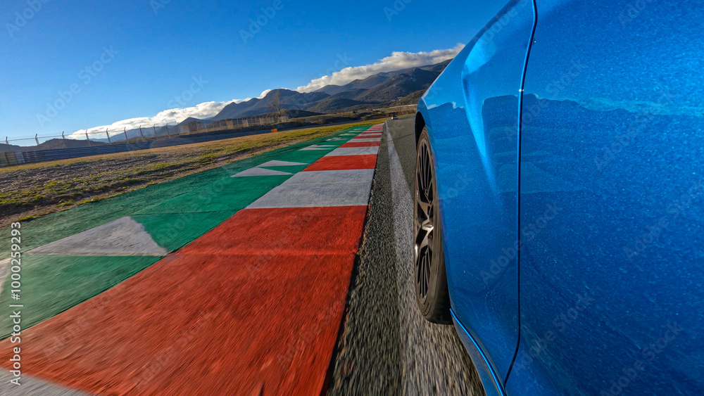 LOW ANGLE, CLOSE UP: Action shot of a brand new luxury car racing on a ...