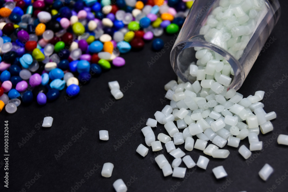 Various colors of mixed masterbatch granules, isolated on a black ...