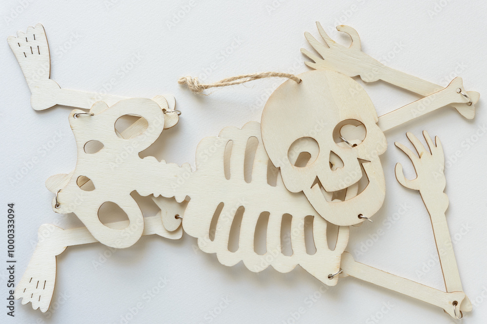 contortionist, crouching laser-cut wooden skeleton with wire joints on ...
