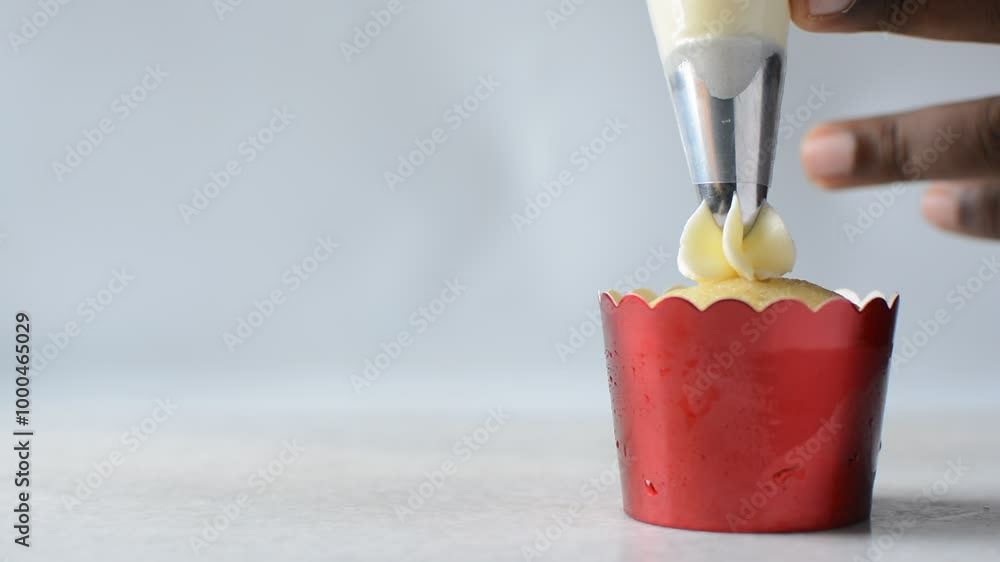 Piping buttercream on a cupcake, decorating cupcakes, hand piping tall ...