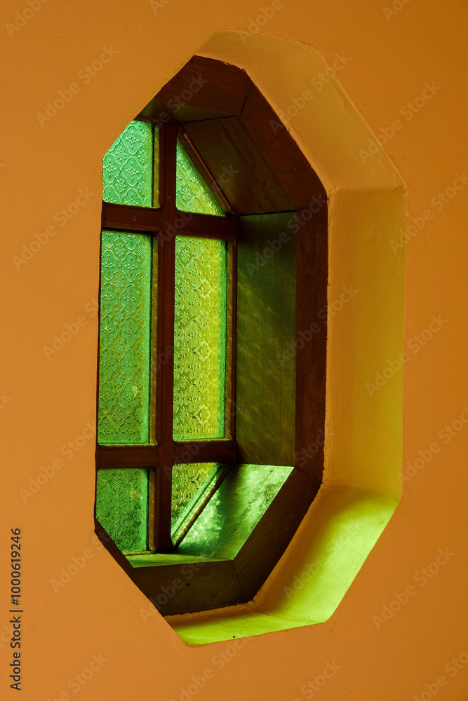 Octagonal Window with Textured Green Glass in Warm Light in a Heritage ...