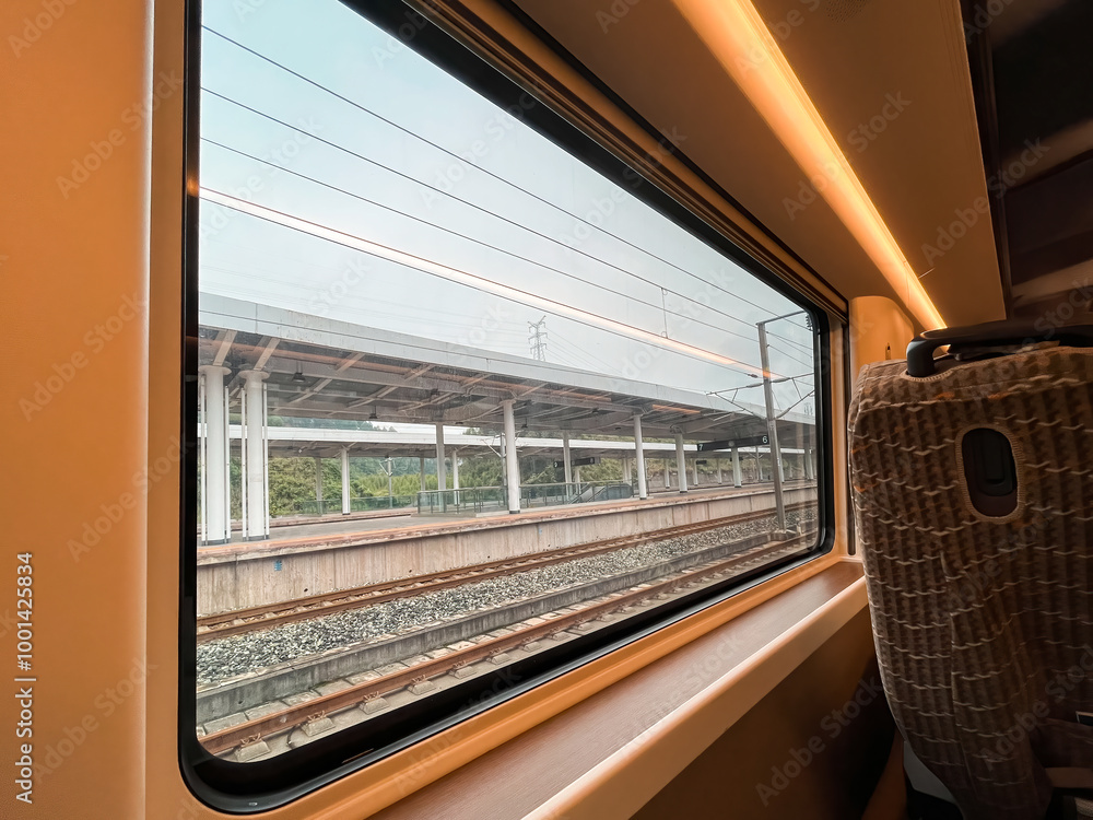 Train seats by the window, looking out at the scenery through the ...