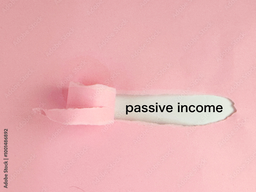 text of PASSIVE INCOME seen through a hole in ripped pink paper. Stock ...