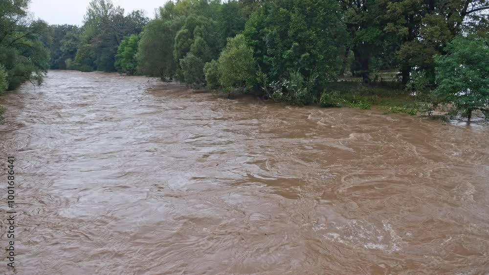 View from a bridge of an overflowing river after torrential rains ...