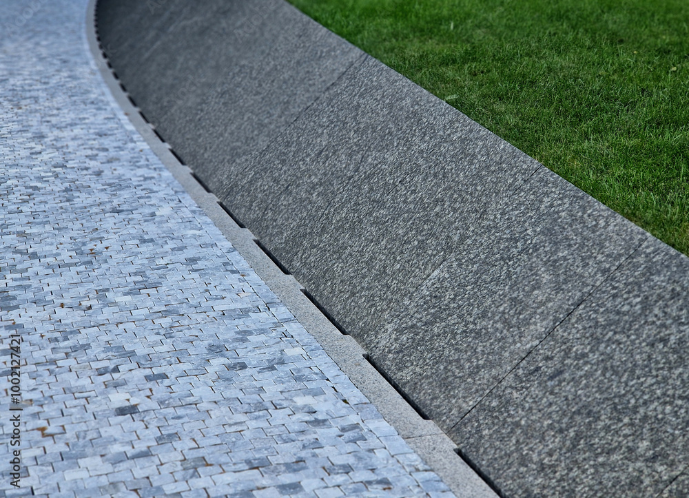 large-format paving made of gray granite. the water is drained in the ...