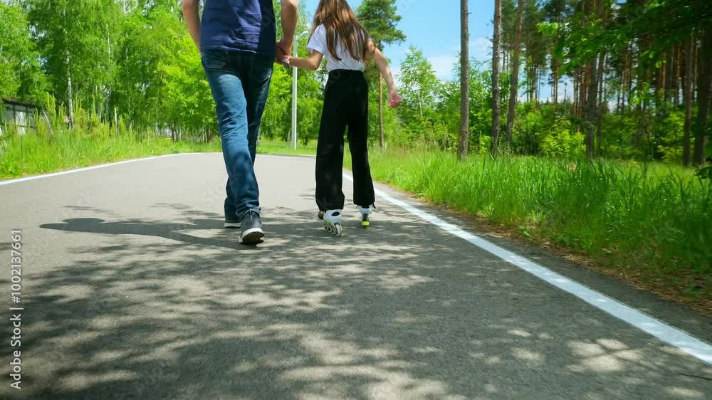 Positive caring father helping cute teenage daughter to ride roller ... Positive caring father helping cute teenage daughter to ride roller ...