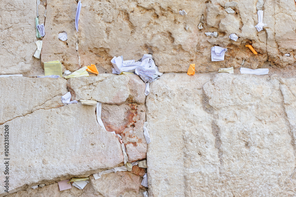 Tiny prayer notes inserted into the cracks and crevices of the Western ...
