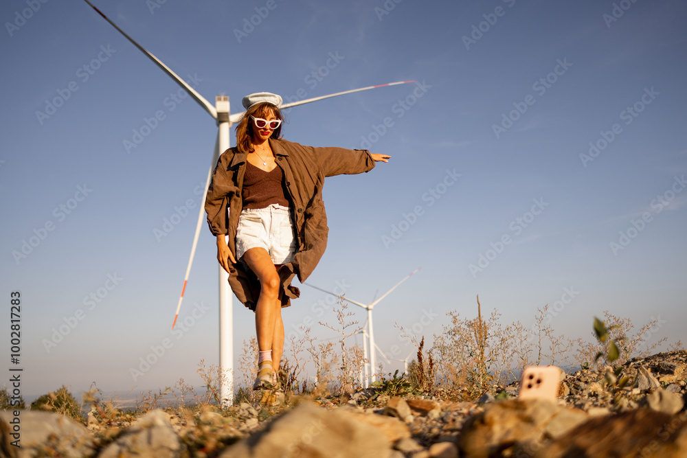 Person with outstretched arms embracing the power of wind energy ...