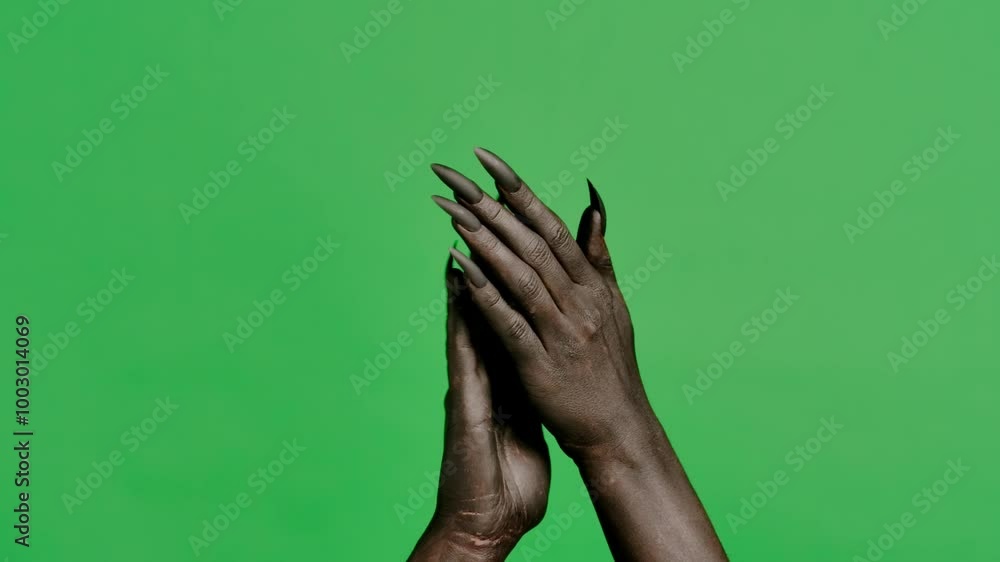 Creepy halloween devil monster hand in black paint with black nails ...