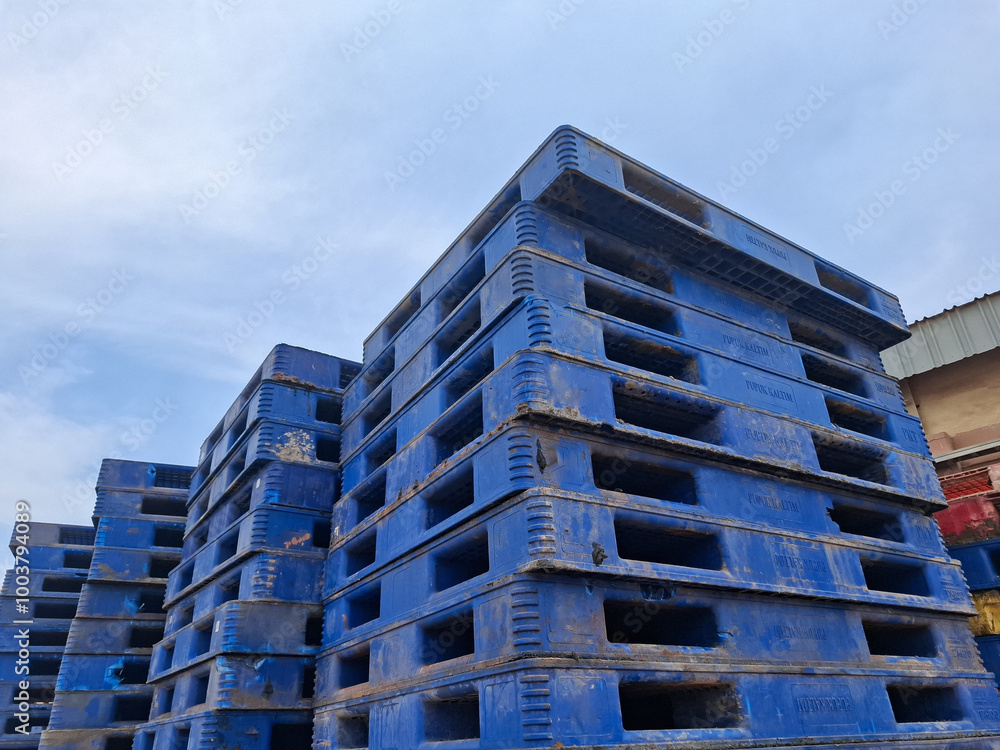 stack of empty plastic pallets in warehouse. concept of shipping and ...