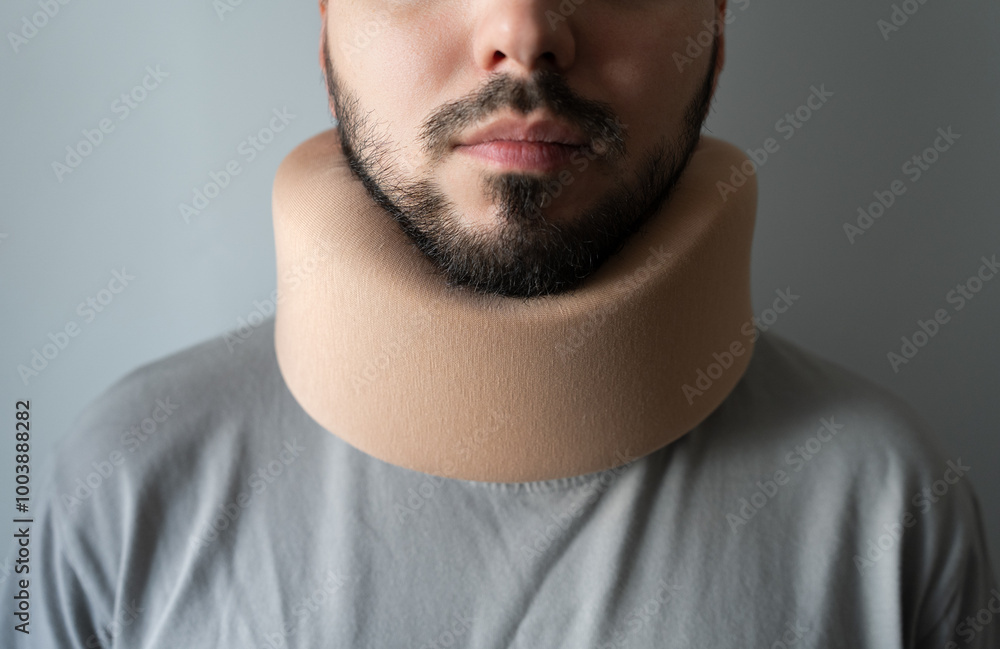 Portrait of young man with cervical collar. Cervical spine stretching ...