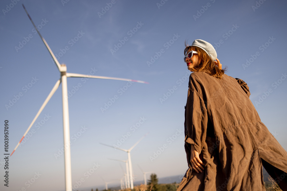 Person with outstretched arms embracing the power of wind energy ...