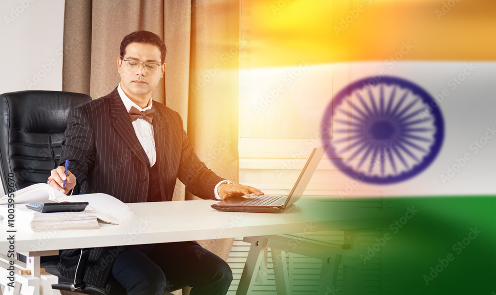 Indian man manager. Office employee at desk. Indian flag near ...