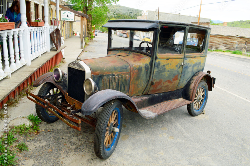 Rusty old 1925 Ford model T Car in front of store in Virginia City. A ...