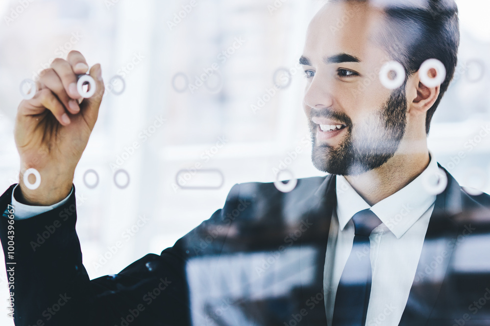 Positive successful male entrepreneur writing finance strategy for ...