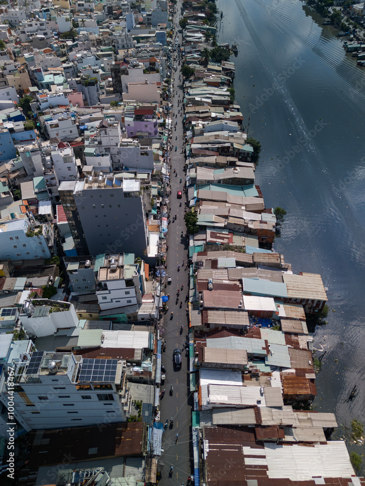 Wide Vertical drone view along the waterfront street and rooftops of a ...