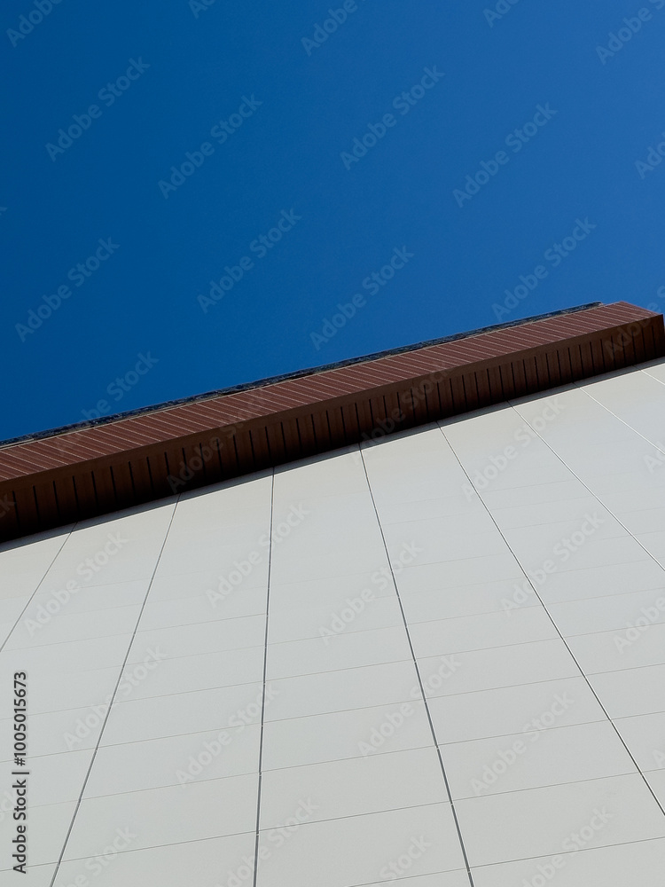 The exterior white wall of a contemporary commercial style building has ...