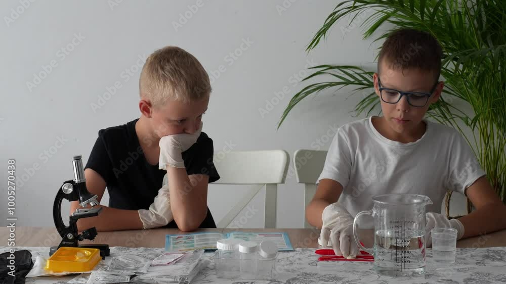 Vídeo do Stock: Two teenagers reviewing instructions before beginning a ...