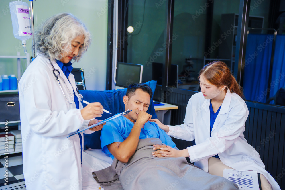 A middle-aged man lies bedridden on hospital bed, closely monitored by ...