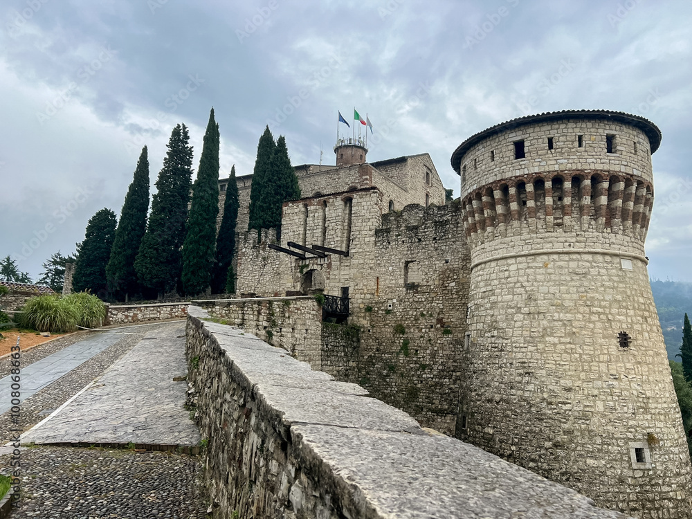 The stone castle features a rectangular shape with a round tower at one ...
