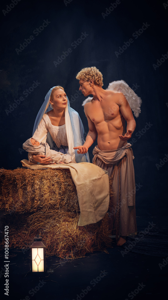 Christmas nativity scene with Mary holding baby Jesus and angel ...