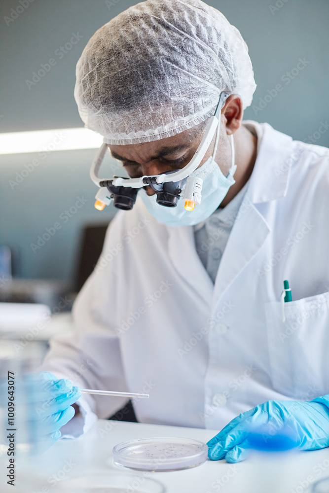 Vertical shot of African American male microbiology scientist wearing ...