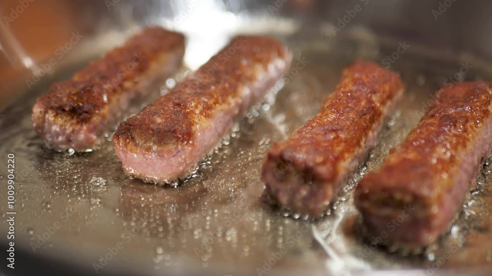 Several fried minced meat slices in boiling vegetable oil in a ...