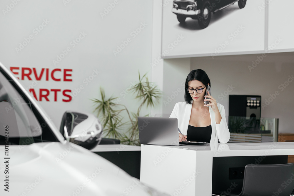 Sales woman use smartphone, have business call at car showroom. Car ...