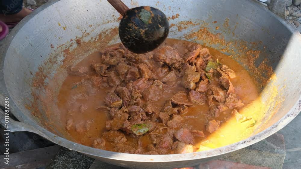 The process of cooking rendang is still half cooked using the ...