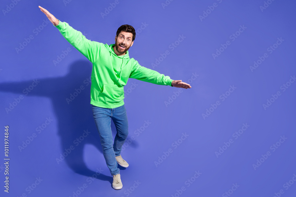 Full length photo of handsome young guy spread hands flying dressed ...