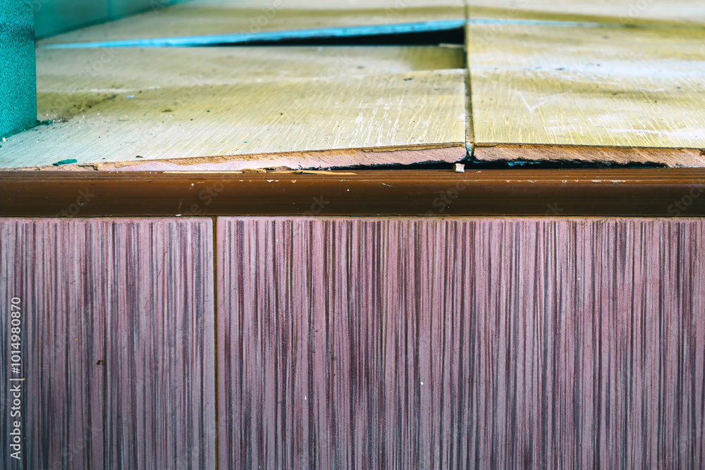 Background with falling off tiled tiles in living room. Close up of ...